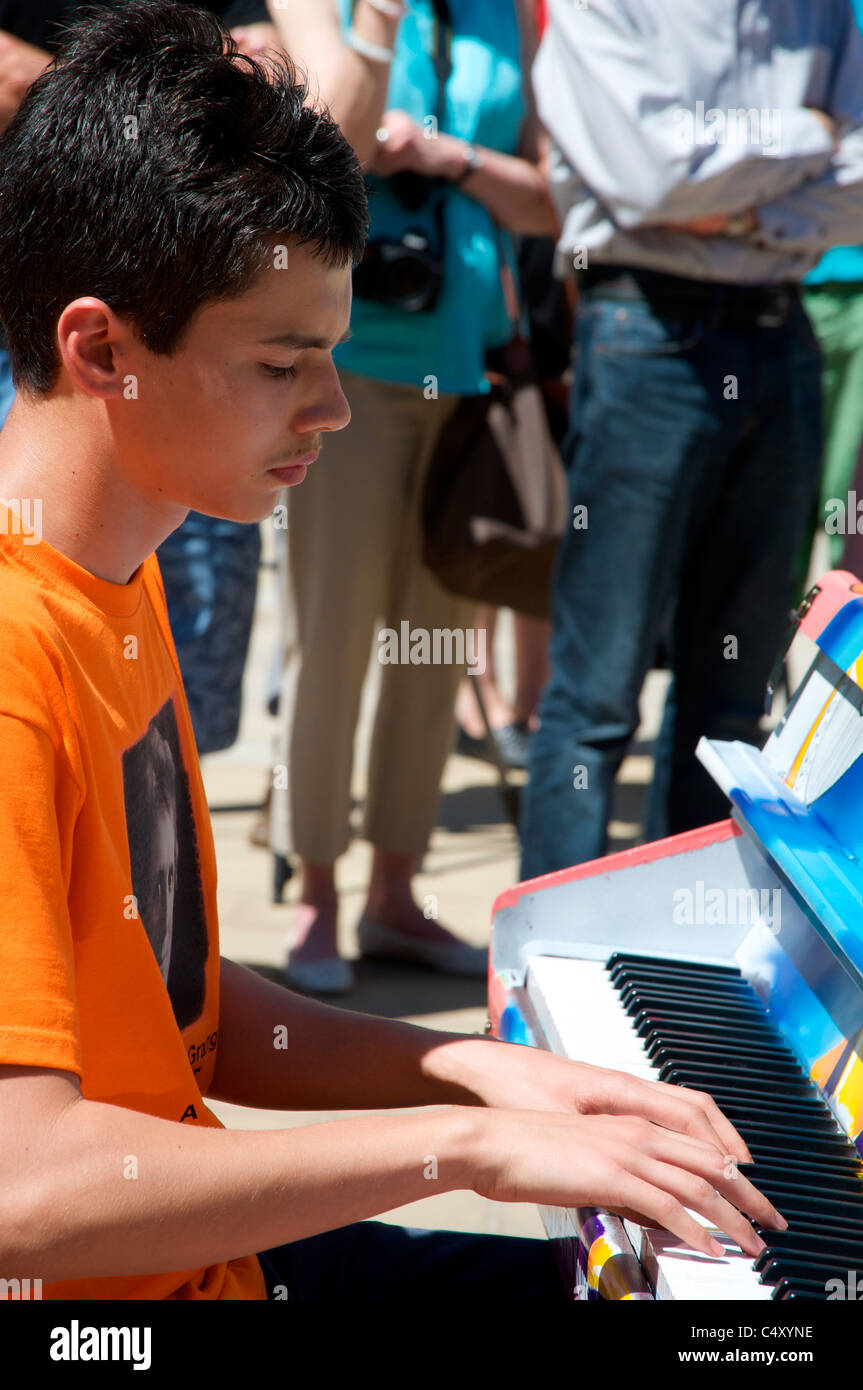 Music student plays street piano in Paternoster Square during the City ...
