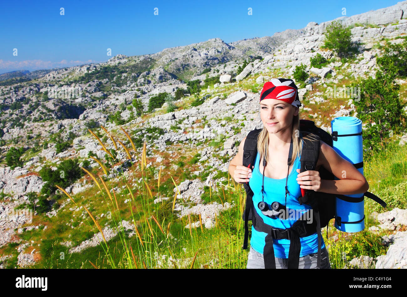 Traveling girl with backpack hiking in the mountains, eco tourism Stock ...