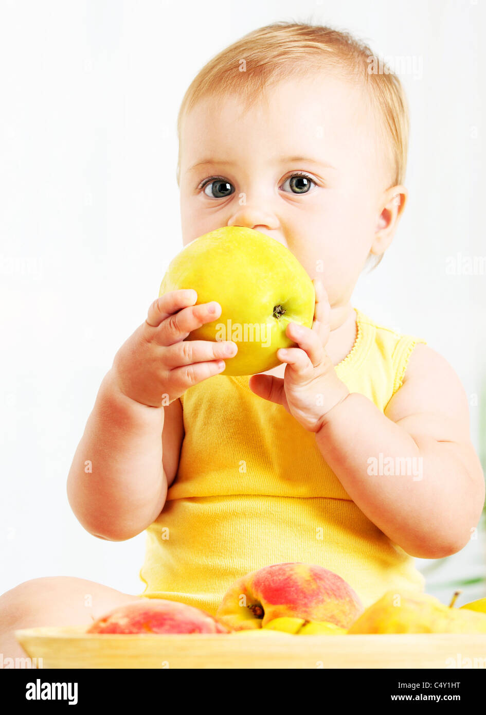 Little baby eating apple, closeup portrait, concept of health care ...