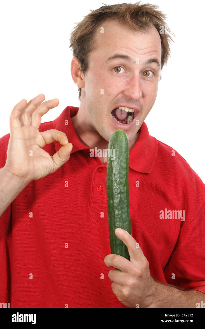young man with a cucumber in his hand Stock Photo - Alamy