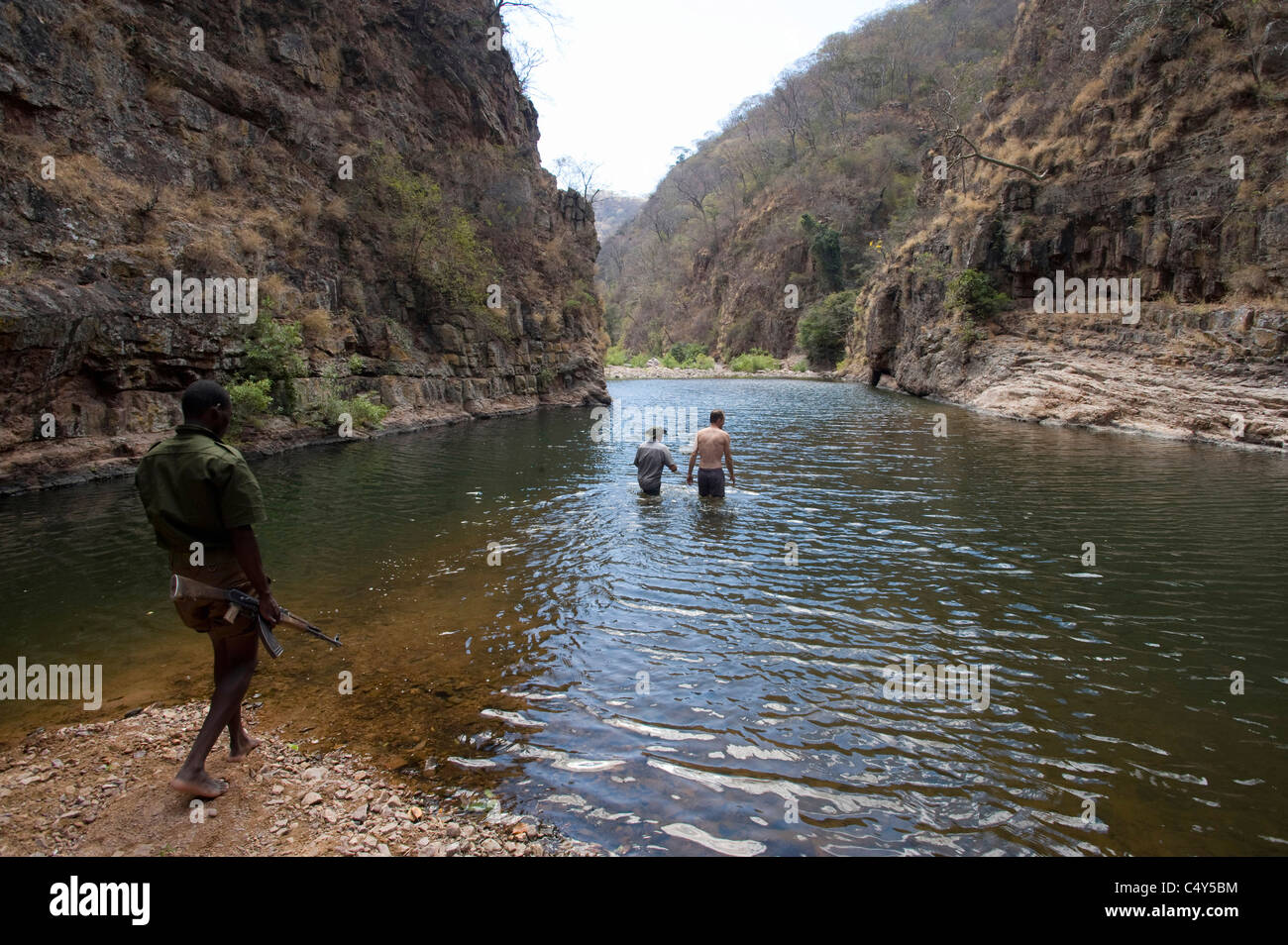 Crossing a deep pool in a gorge in Zimbabwe's Chizarira National Park ...
