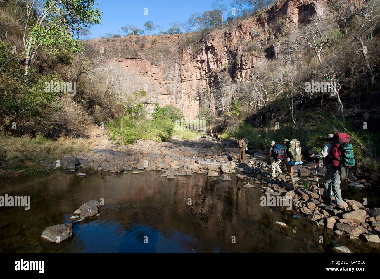 Crossing a deep pool in a gorge in Zimbabwe's Chizarira National Park ...