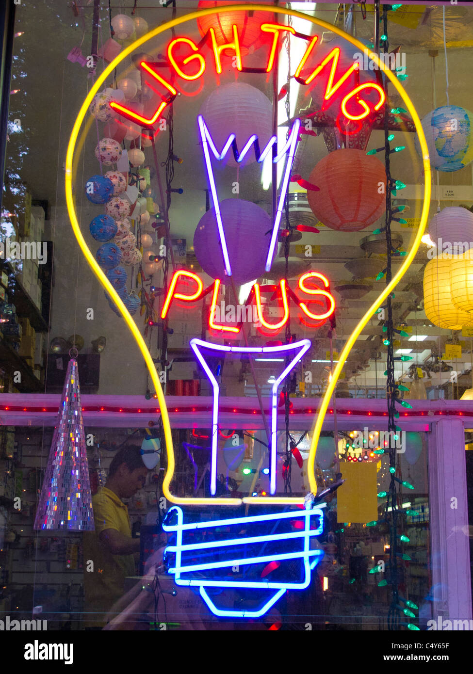 Lighting plus neon store sign Stock Photo - Alamy