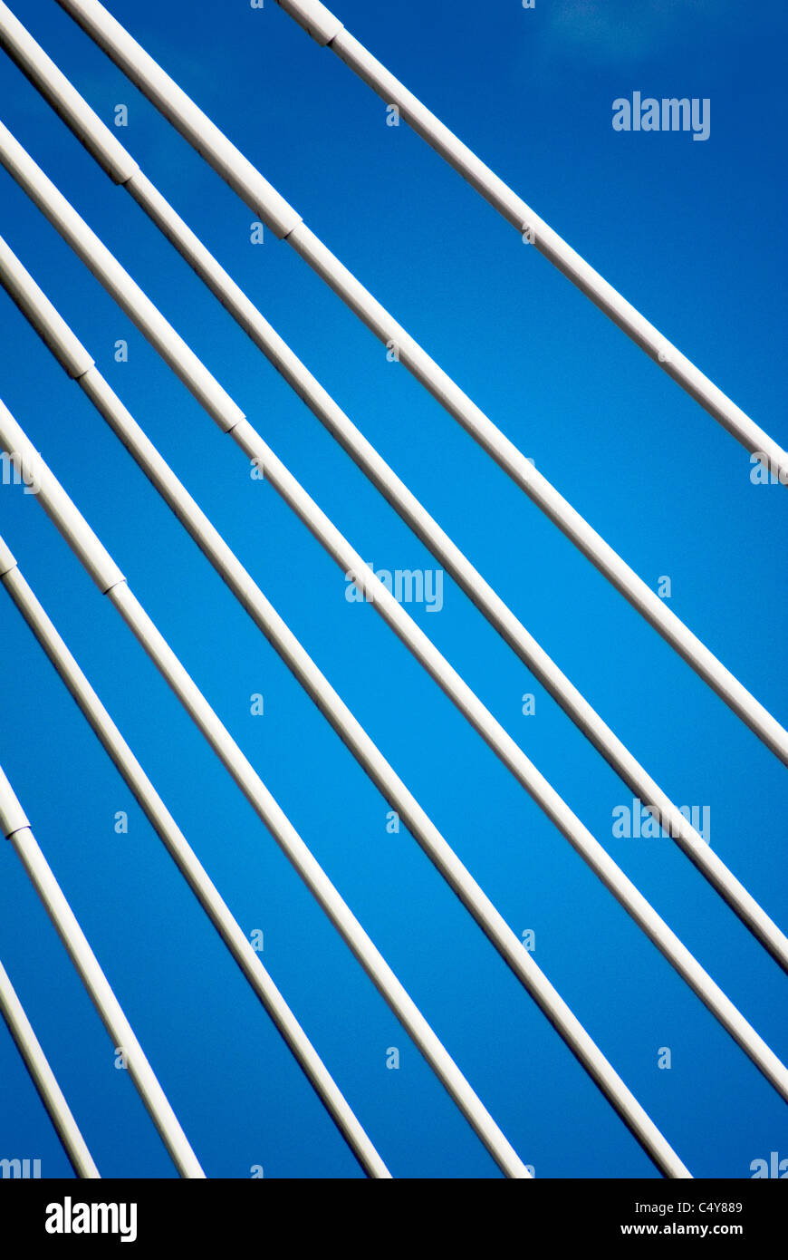 a striking graphic image of the guide bars of a bridge against a bright ...