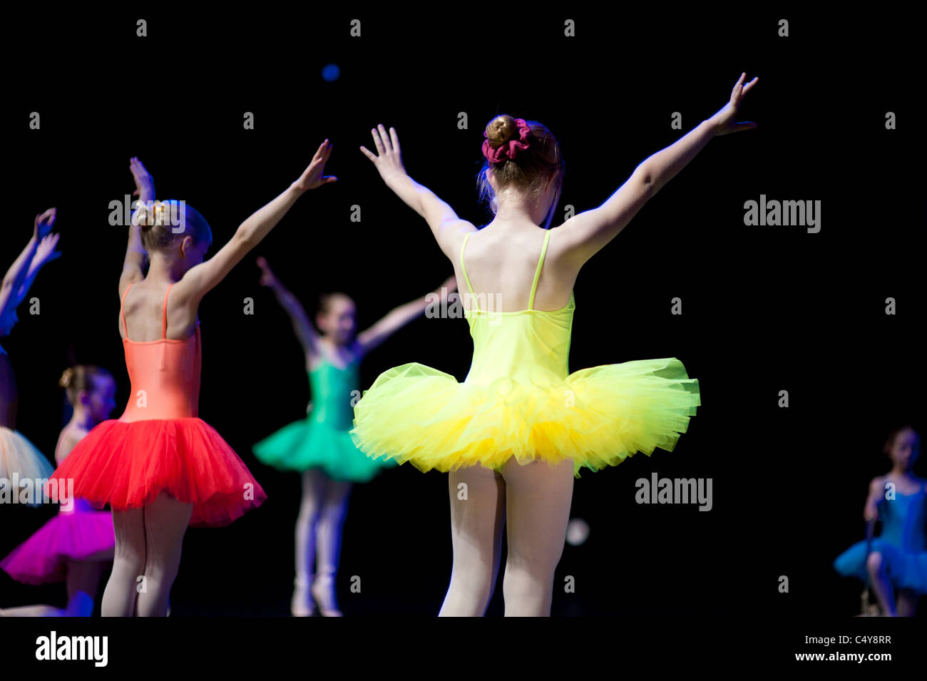 Young girls ballet dancing wearing bright colourful yellow red green ...
