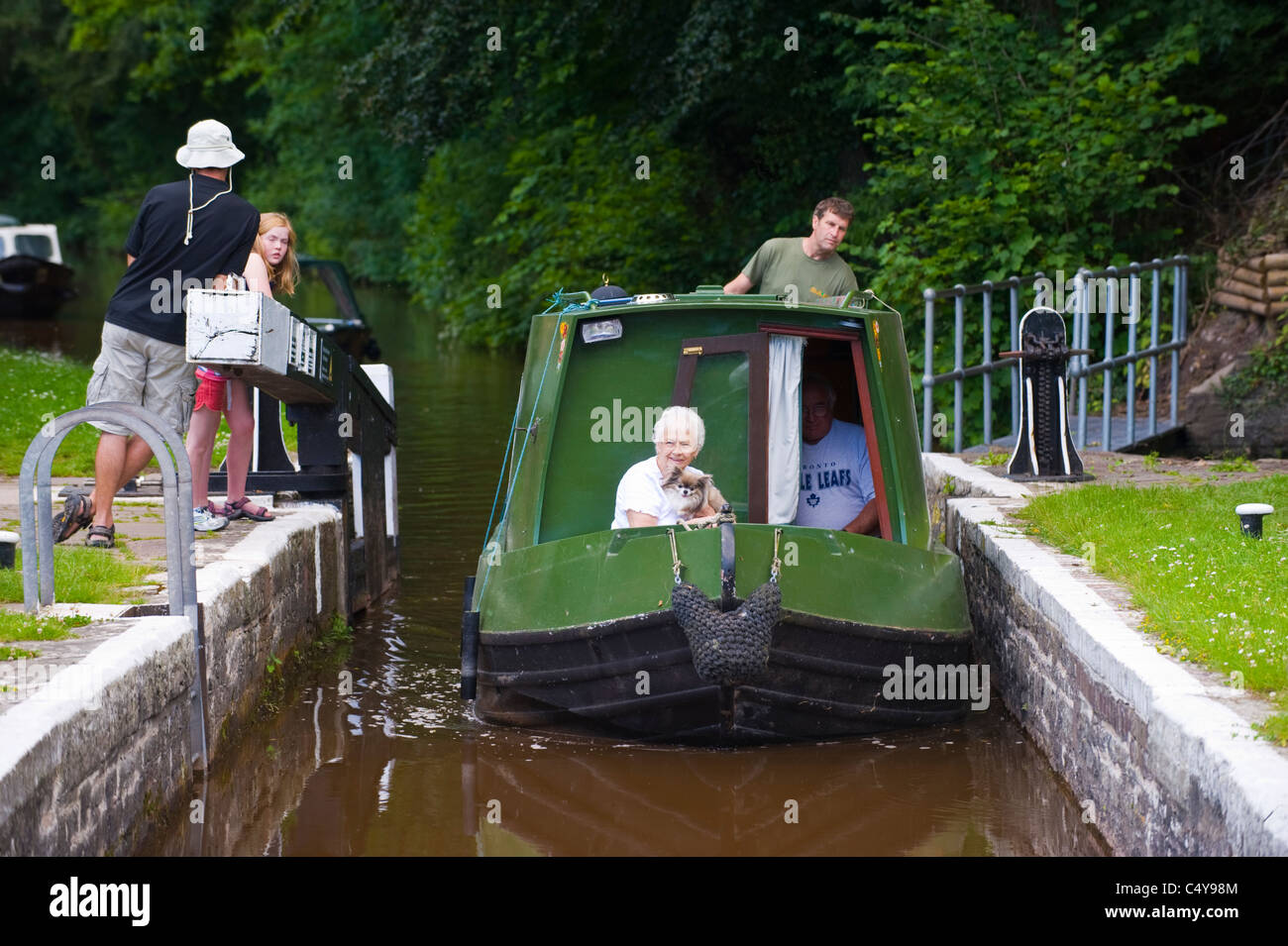 Small narrowboat going through lock on canal near Brecon Powys South ...
