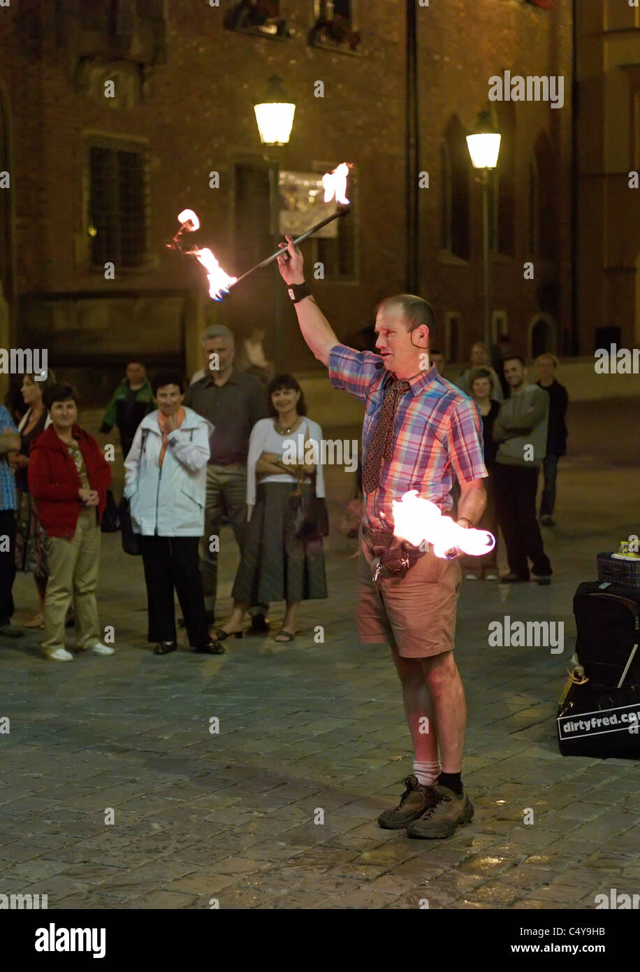People watching a juggler's fire performance on the market square ...