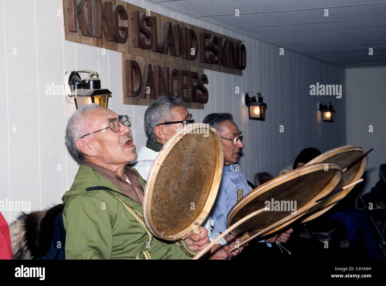 Elderly Alaskan Inupiat Eskimos play their traditional hand drums to ...