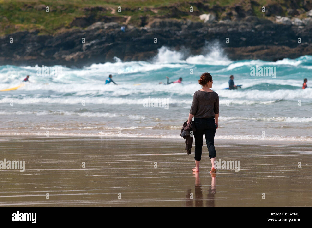 A woman walking across Fistral beach in Newquay. Photo by Gordon ...