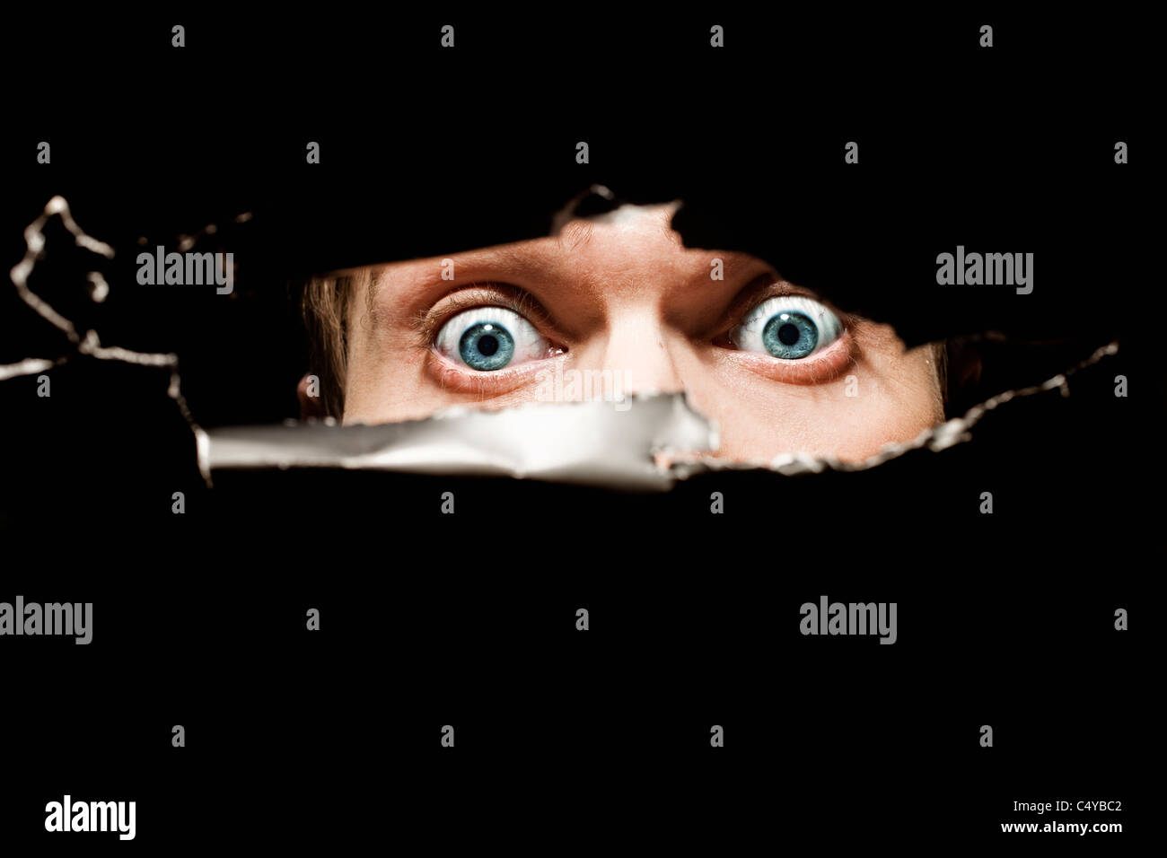 Man spying through hole in hi-res stock photography and images - Alamy