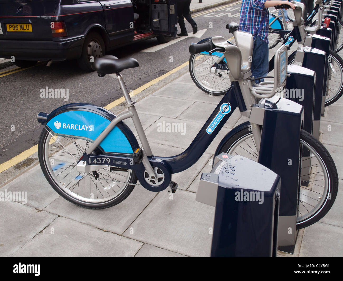 Barclays London Bike Hire scheme bikes and empty docking spaces. A ...