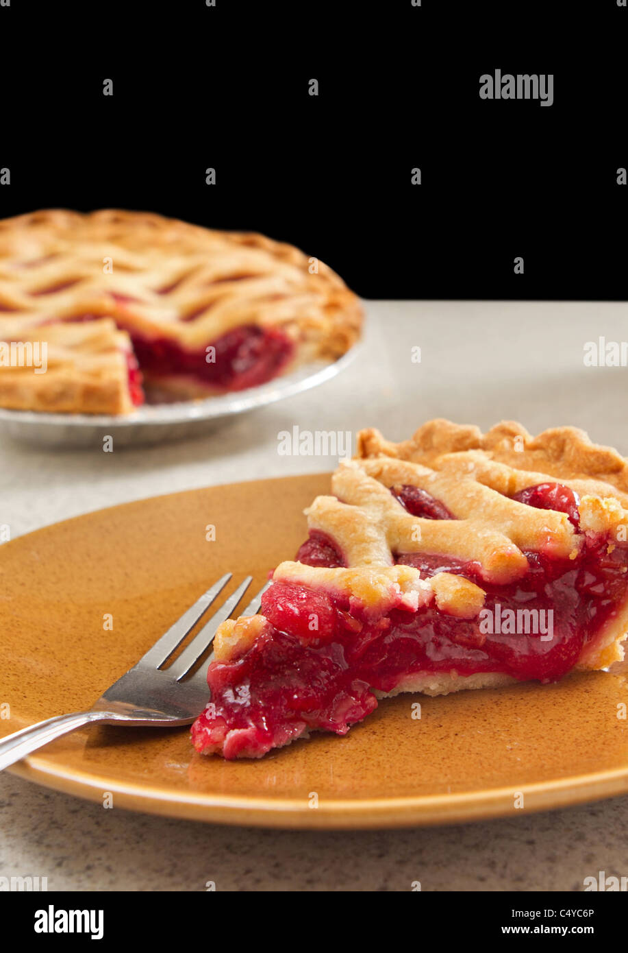 one slice of cherry pie taken out of the whole Stock Photo - Alamy