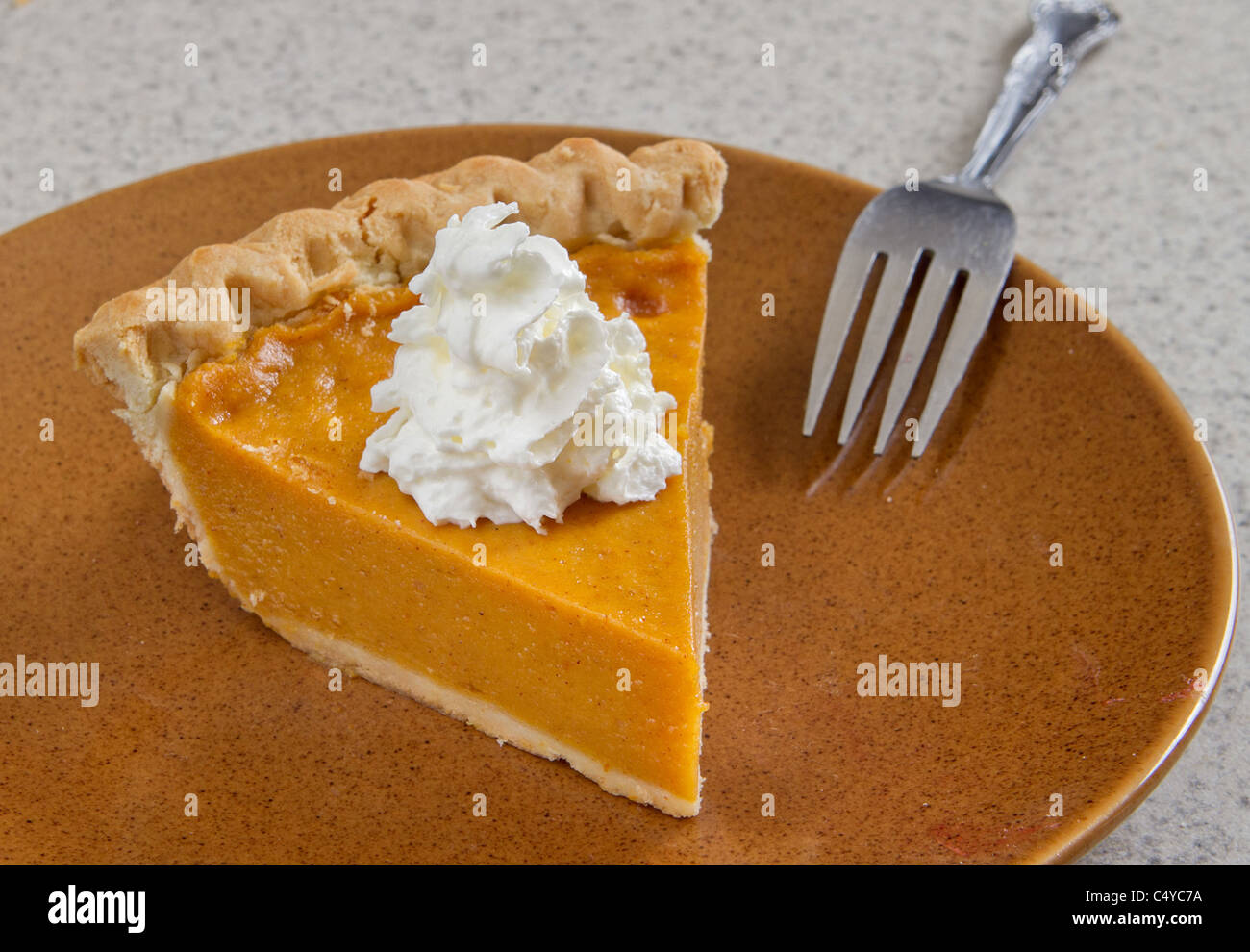 one slice of homemade pumpkin pie with whipped cream Stock Photo - Alamy