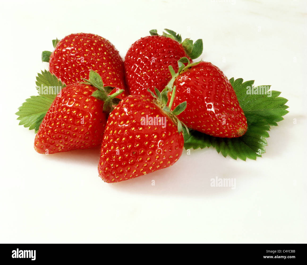 Cut out strawberries with leaves Stock Photo - Alamy