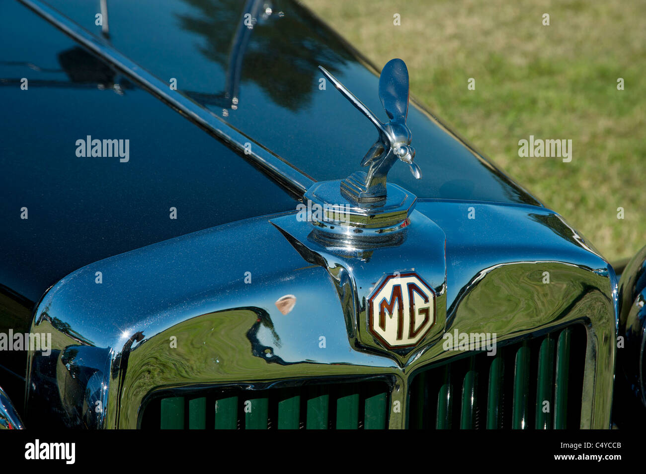 MG badge on MG T roadster with winged hood ornament Stock Photo - Alamy