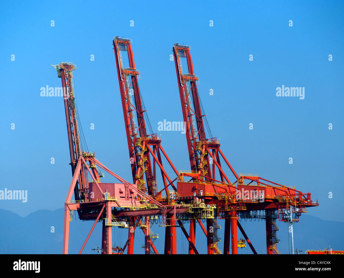 Three cranes in sea port Stock Photo - Alamy