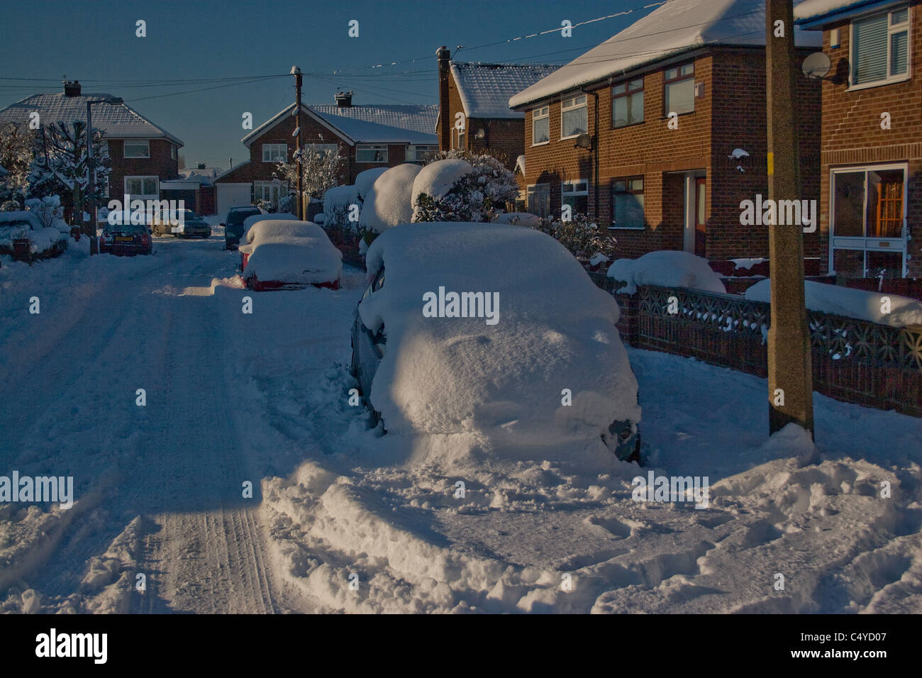 Late after noon sun,blue sky ,snow covered cars Stock Photo - Alamy