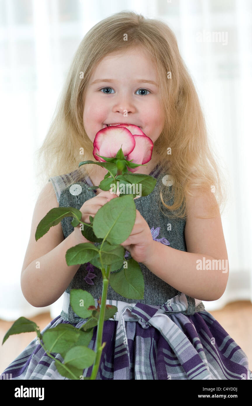 beautiful little girl with pink of rose Stock Photo - Alamy