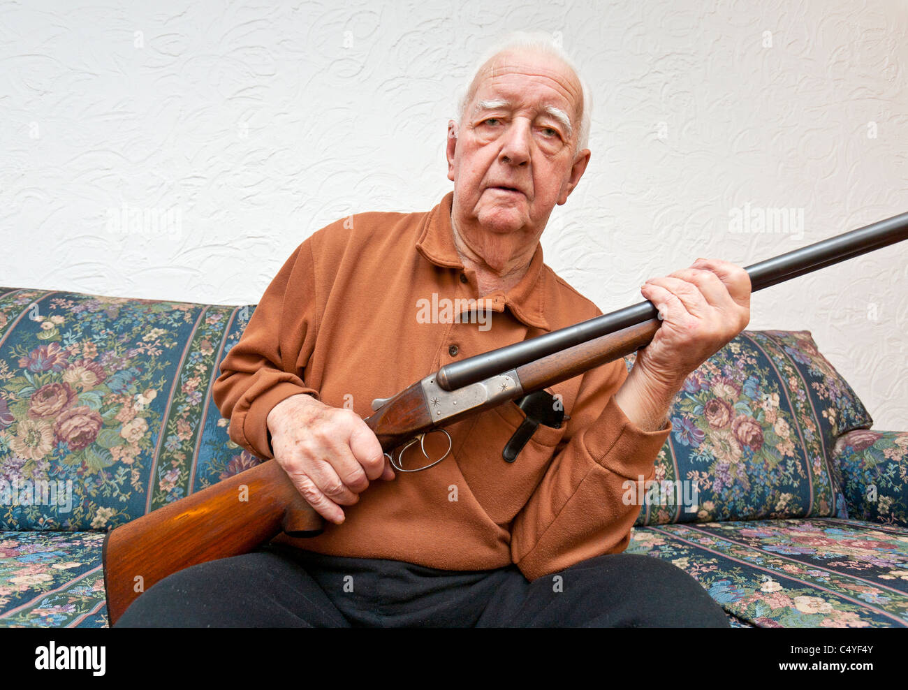 A retired elderly Senior Man holding a shotgun Stock Photo - Alamy