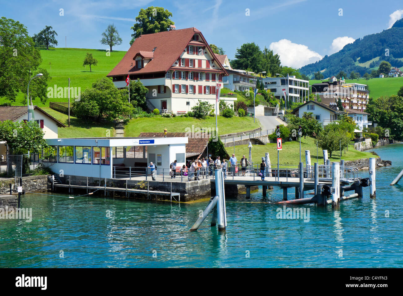 Charming little pier at Hertenstein on the Lake Lucerne in Switzerland ...