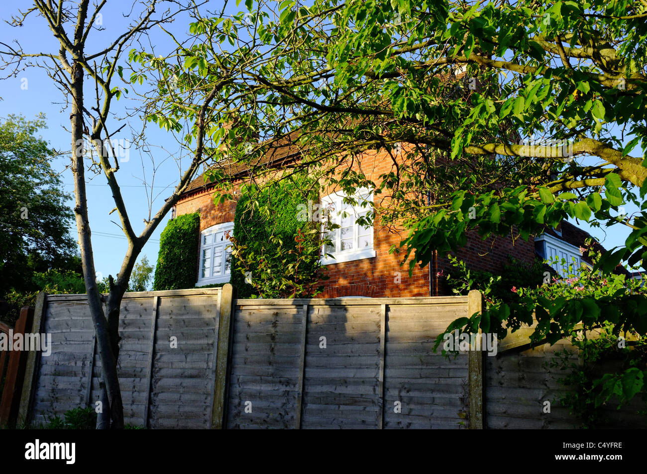 cottage house home property real estate fence fencing Stock Photo - Alamy