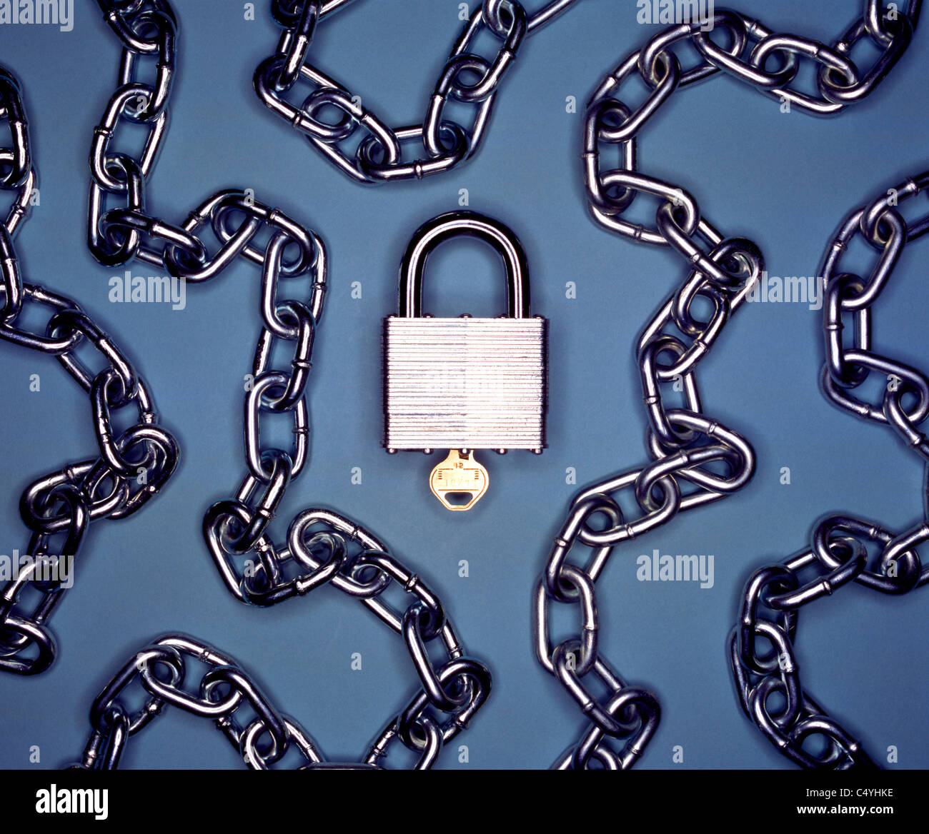 A silver metal padlock and key with many links of chain Stock Photo - Alamy