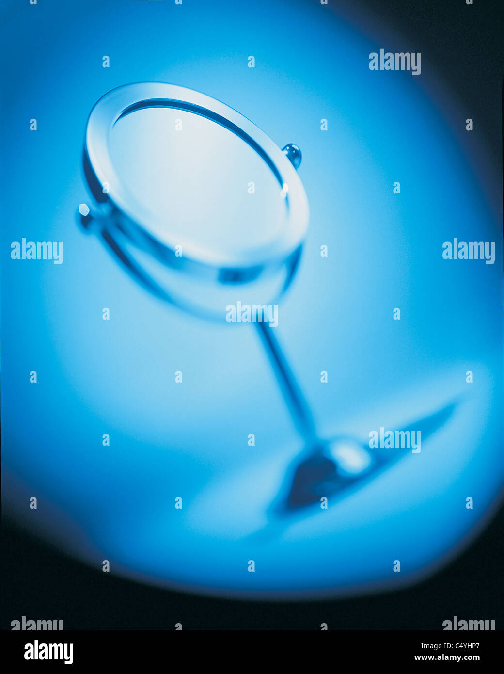 A small round table mirror with blue tones and selective focus Stock ...