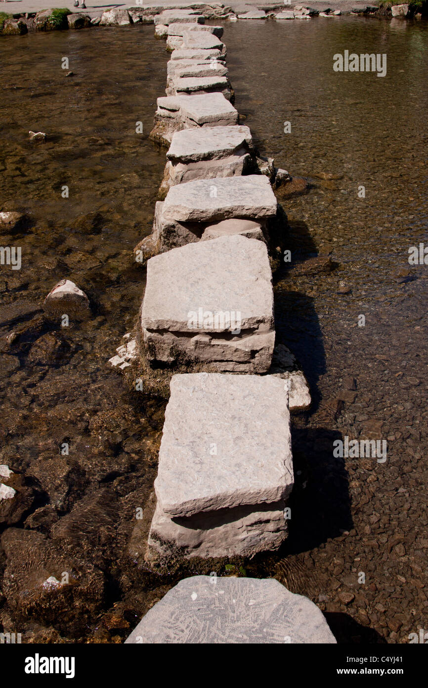 Stepping stones across a river Stock Photo - Alamy