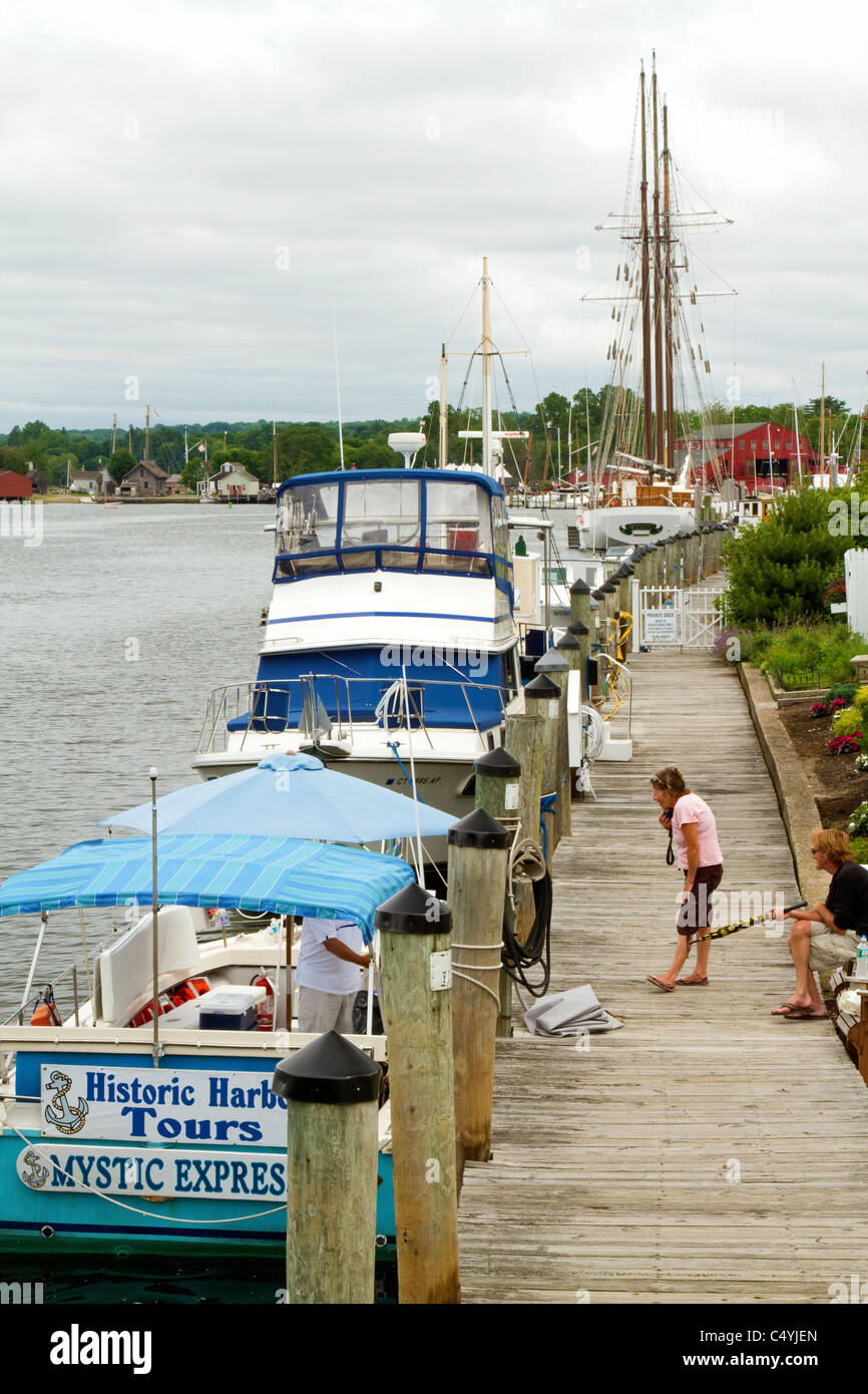 Mystic Seaport, tourists talk with tour guide on the dock at Mystic ...