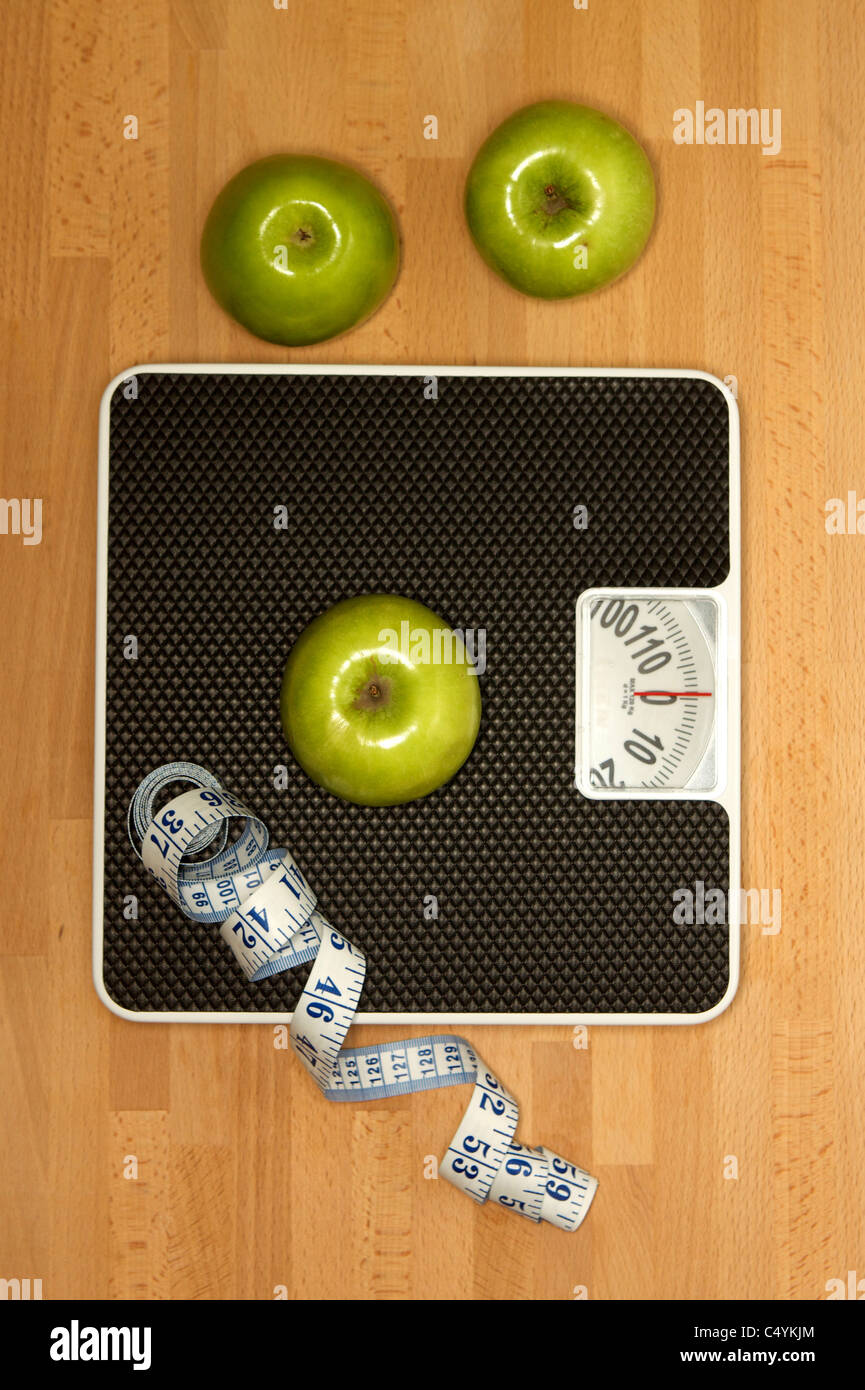 Body bathroom scales on a wooden floor Stock Photo - Alamy