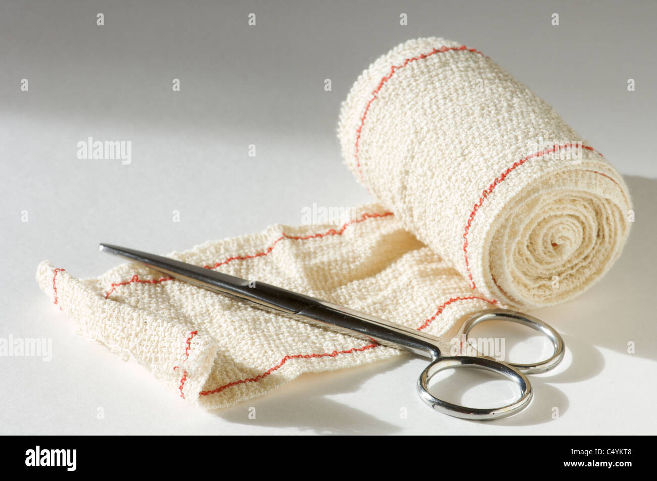 medical scissors and bandages with white background Stock Photo - Alamy