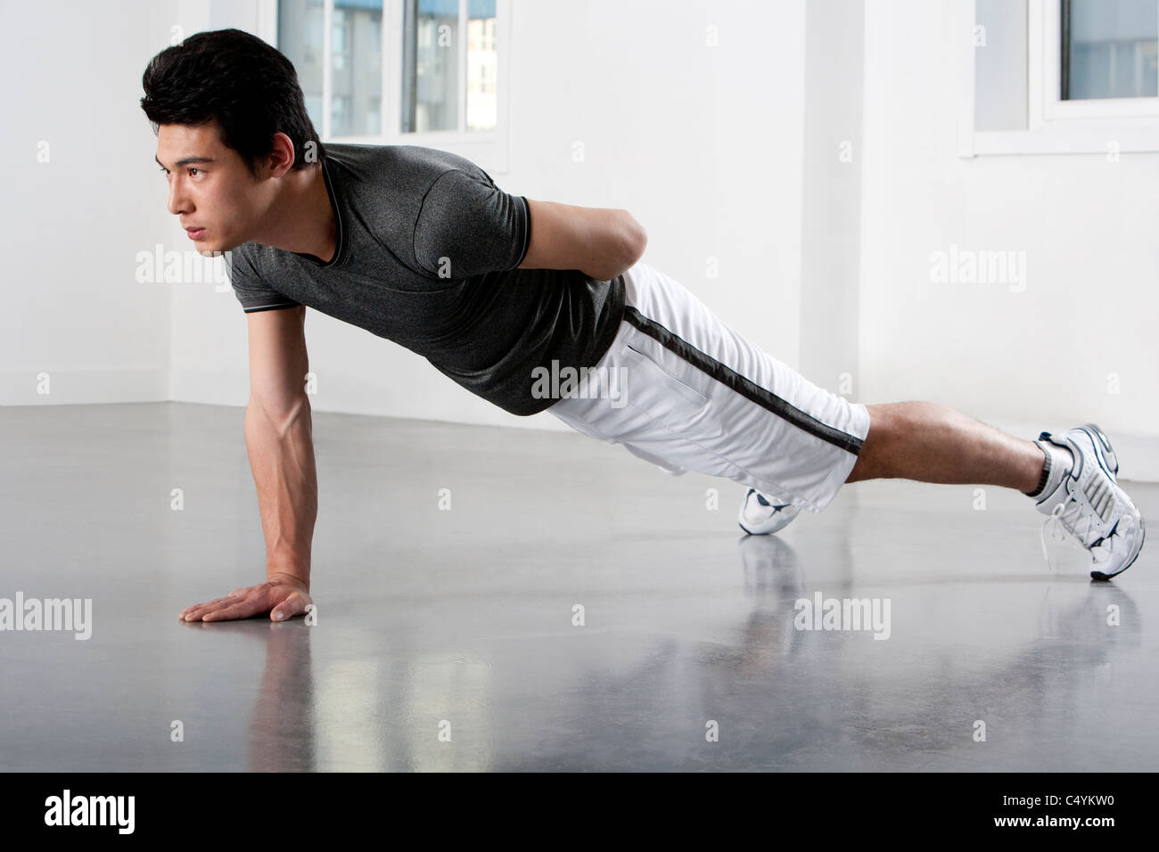 Man Doing One Handed Push-Ups Stock Photo - Alamy