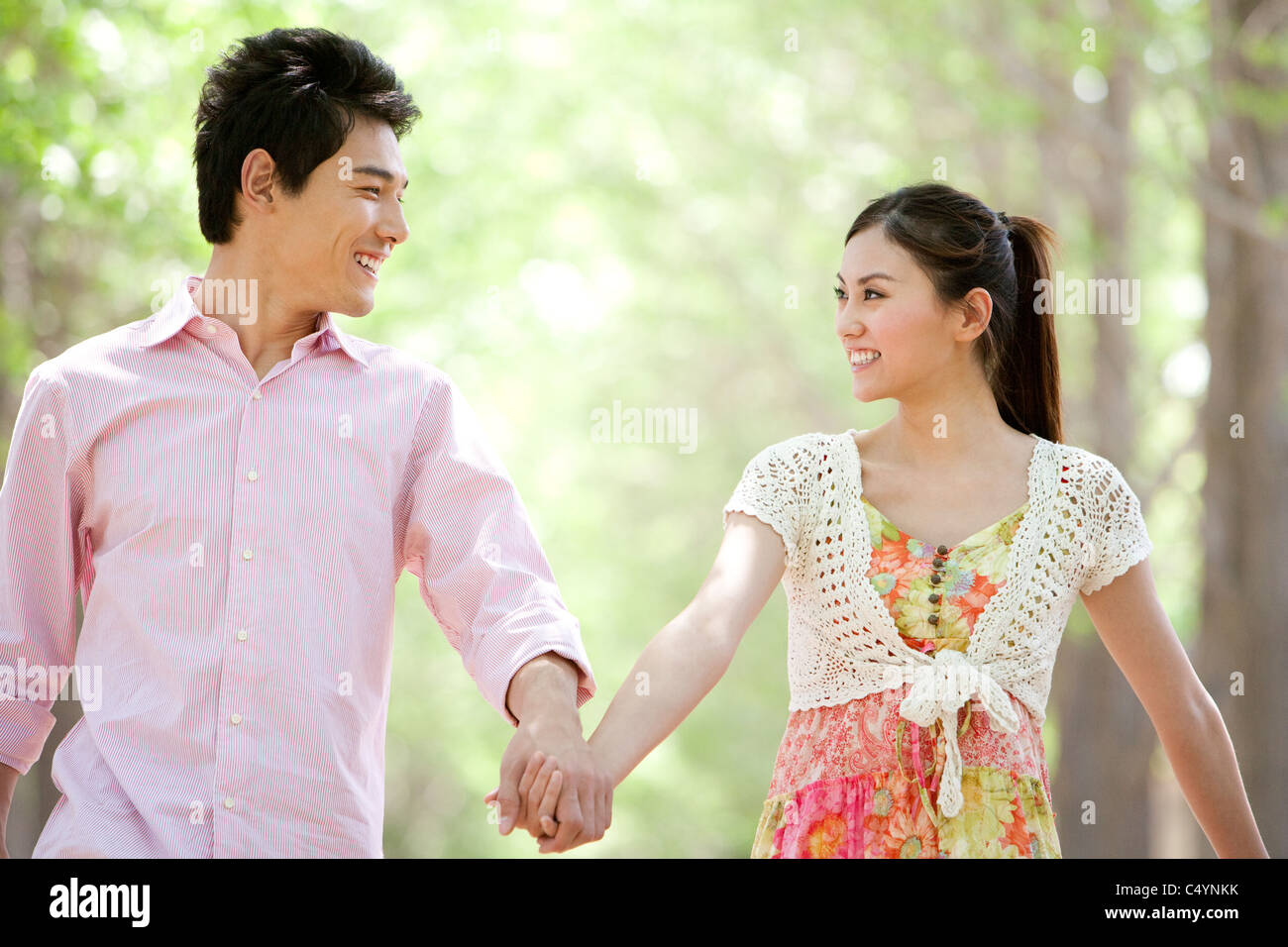 Happy Young Couple Walking Through the Park Stock Photo - Alamy