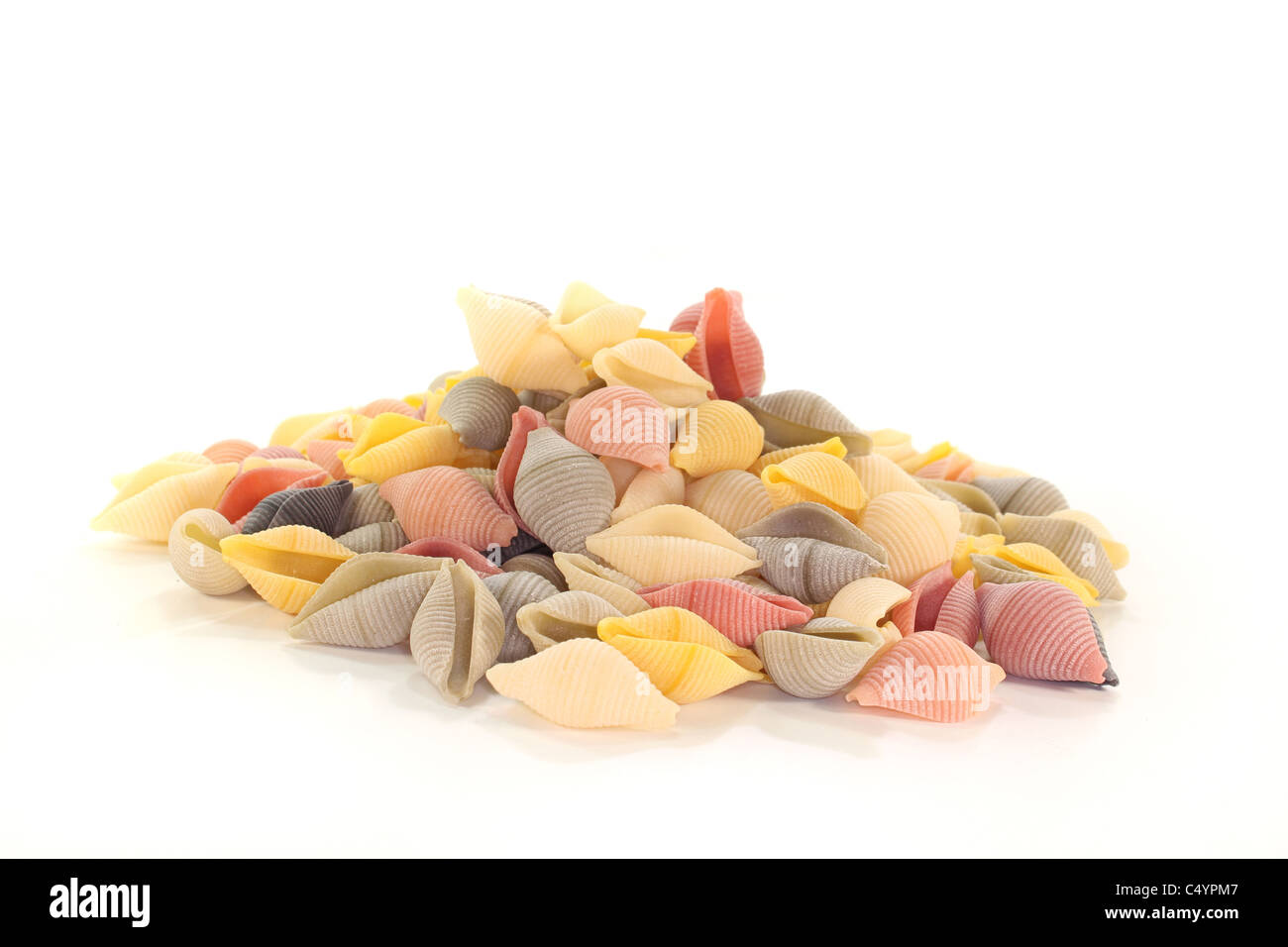 a handful of colored pasta on white background Stock Photo - Alamy