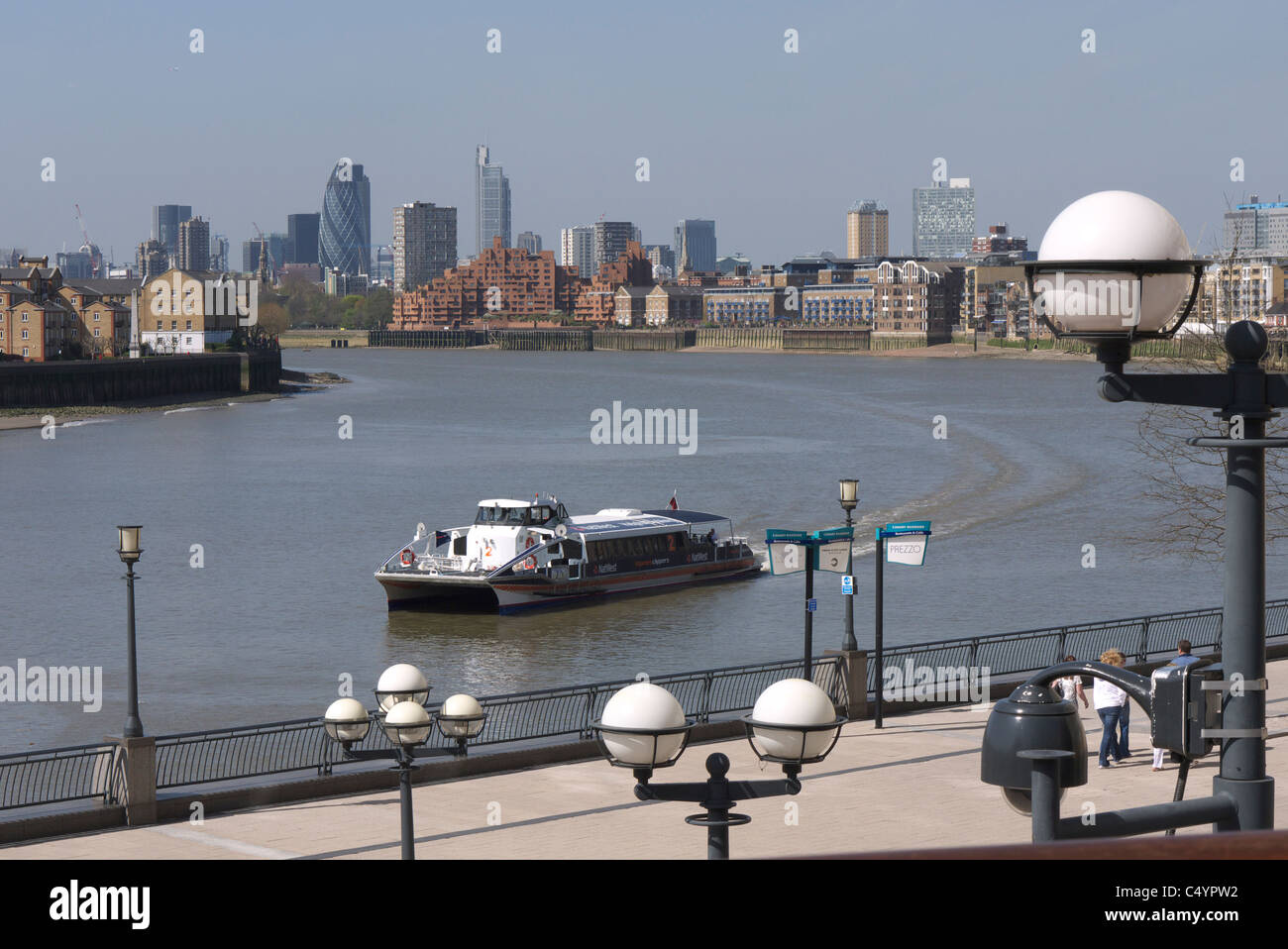 the river Thames looking west into London as a water bus come in to ...