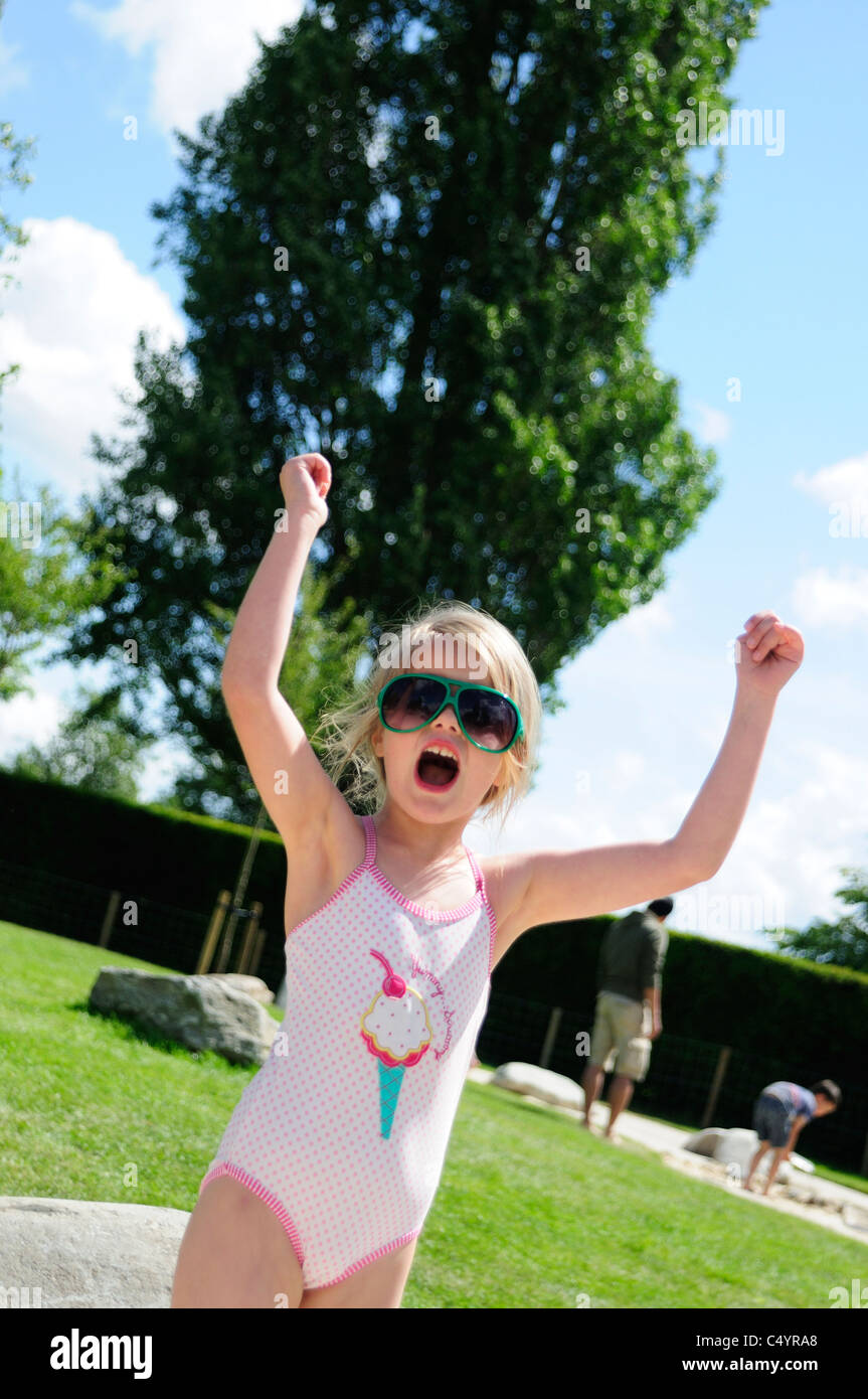 Girl at paddling pool in park Stock Photo - Alamy