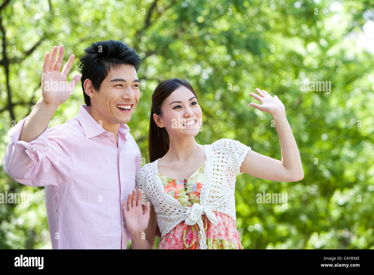 Young Couple Waving Stock Photo - Alamy