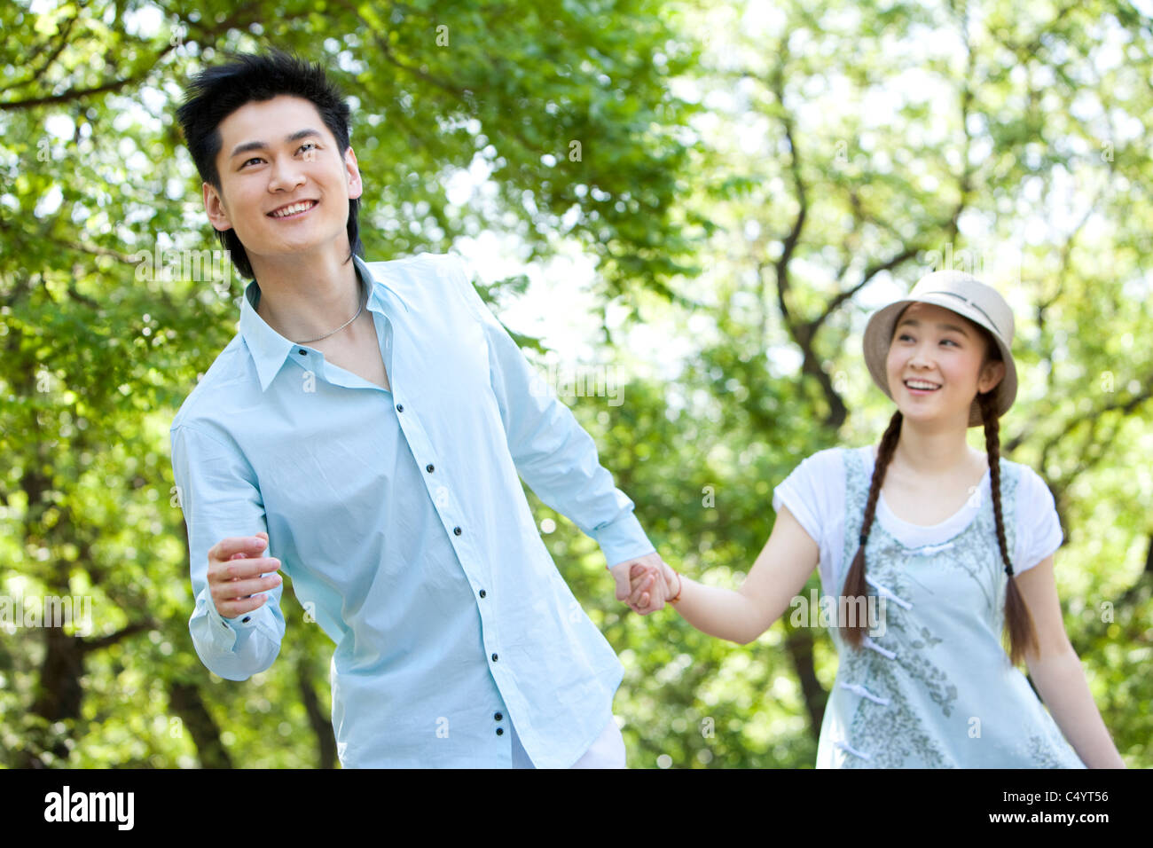 Happy Couple Walking Through the Park Stock Photo - Alamy