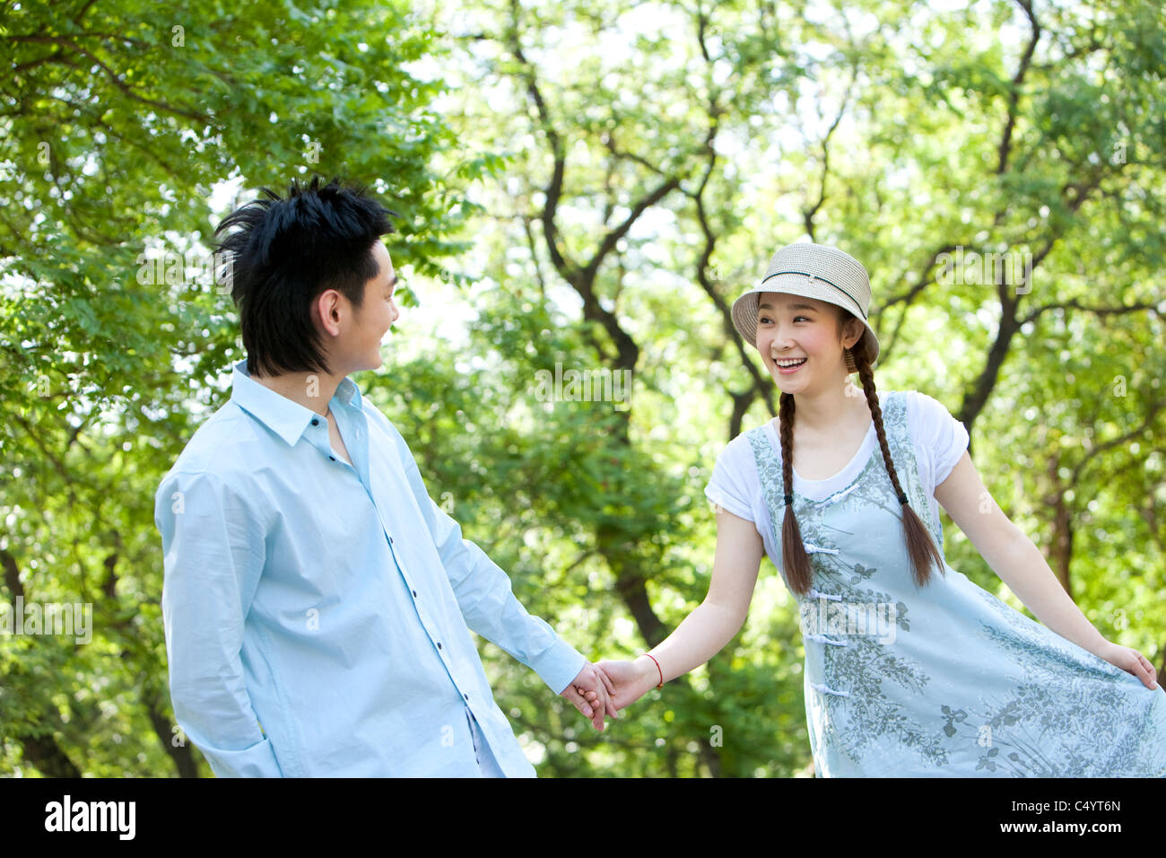 Happy Couple Walking Through the Park Stock Photo - Alamy