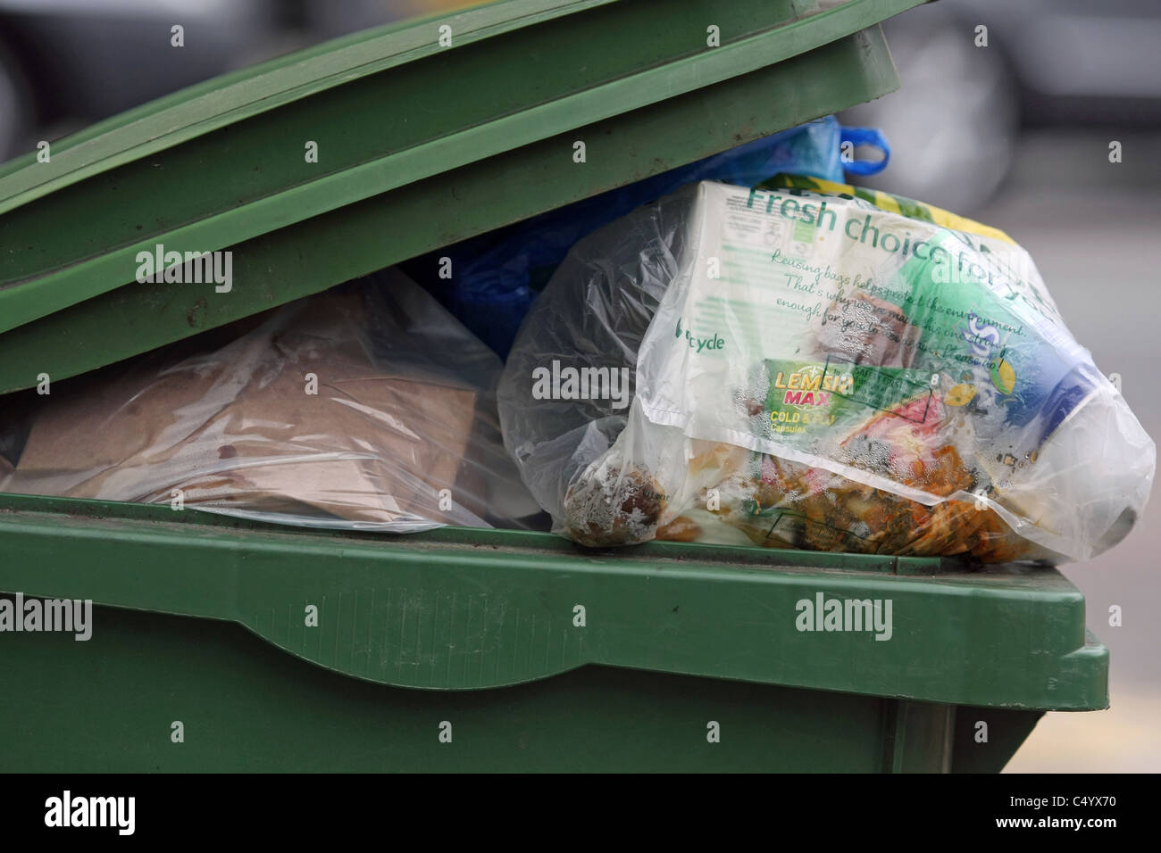 A close up of a wheelie bin full of rubbish Stock Photo - Alamy