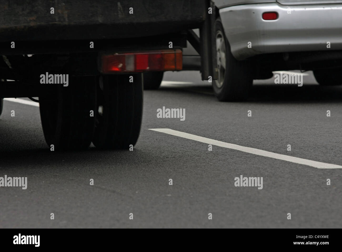 The wheels of vehicles moving along a road in London, England Stock ...