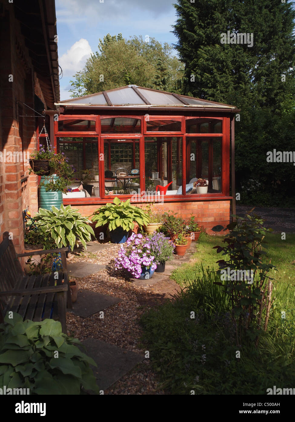 conservatory tables chairs plants room in house next to garden Stock ...