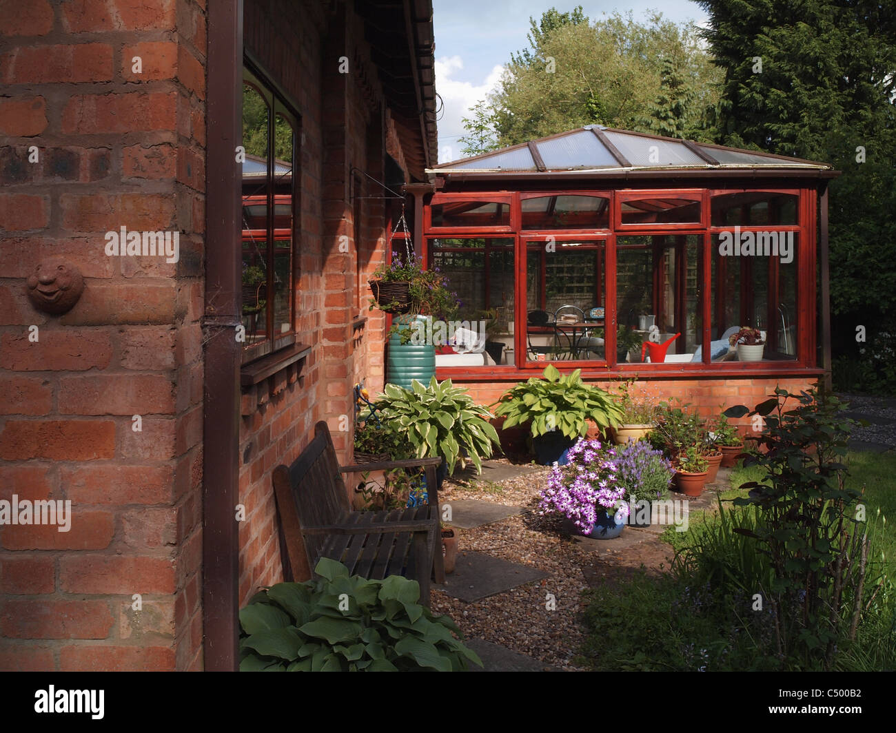 conservatory tables chairs plants room in house next to garden Stock ...