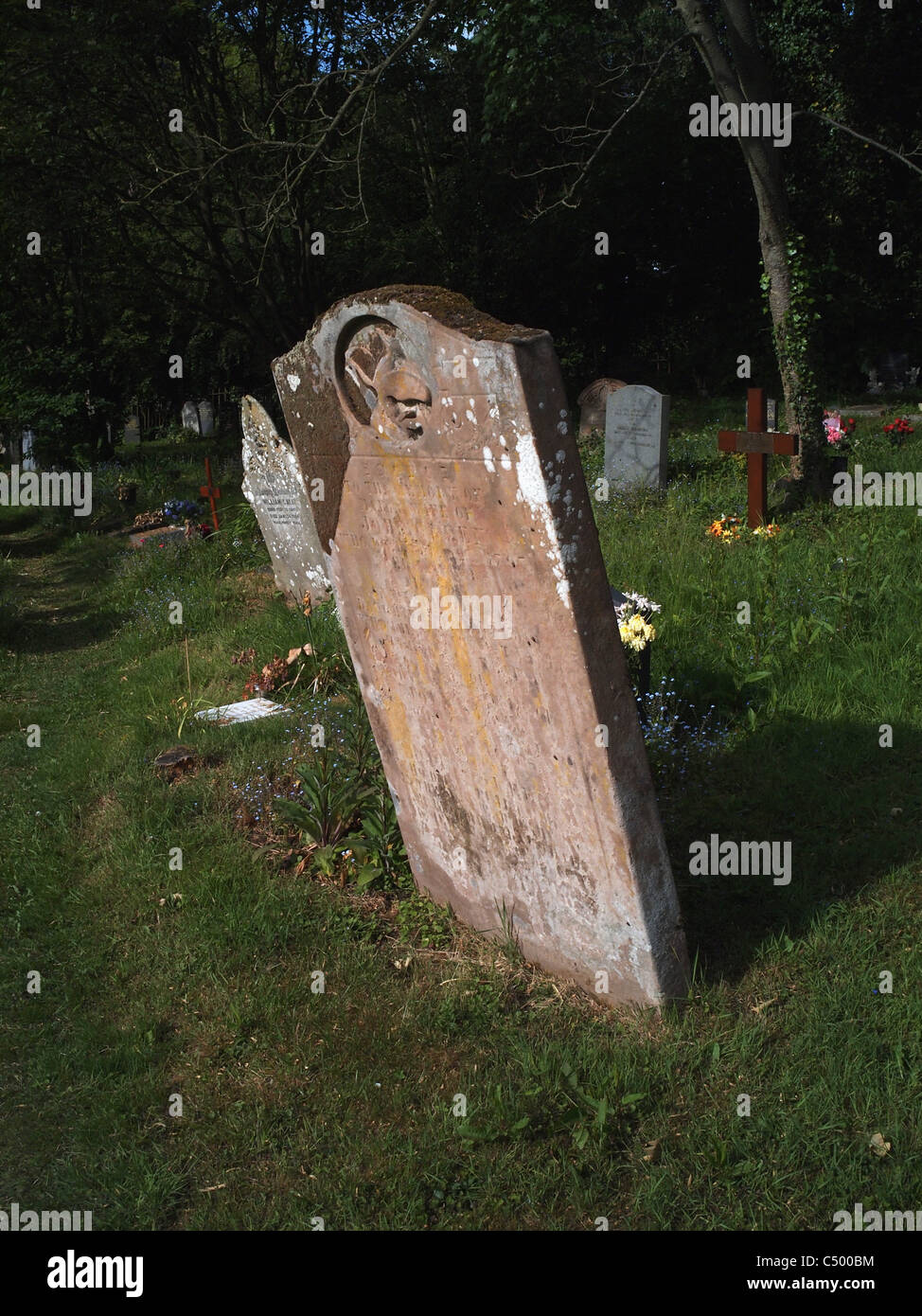gravestones lit by the sun in a country cemetery Stock Photo - Alamy