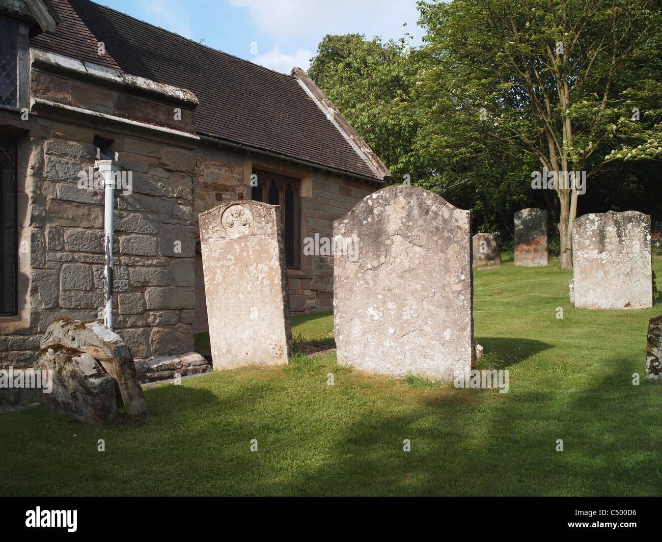 gravestones lit by the sun in a country cemetery Stock Photo - Alamy