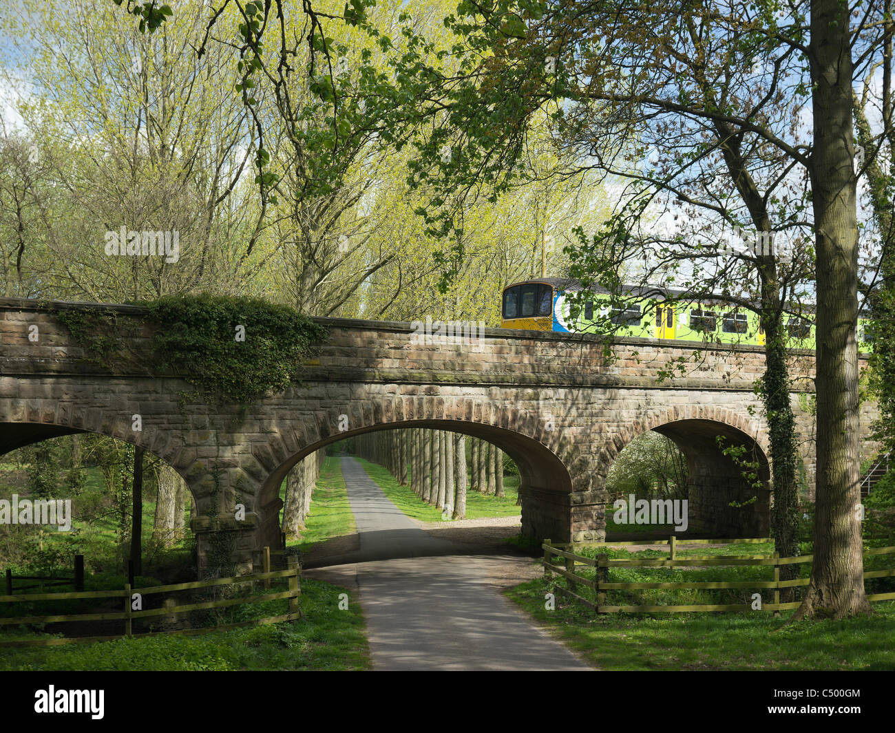 A train on a railway line in the countryside Stock Photo - Alamy