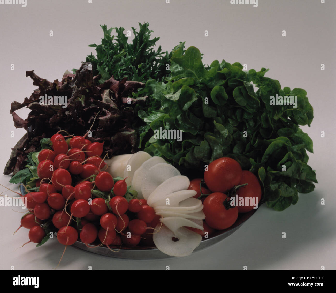 Cut out:Small radish, radish, tomato, lettuce Stock Photo - Alamy