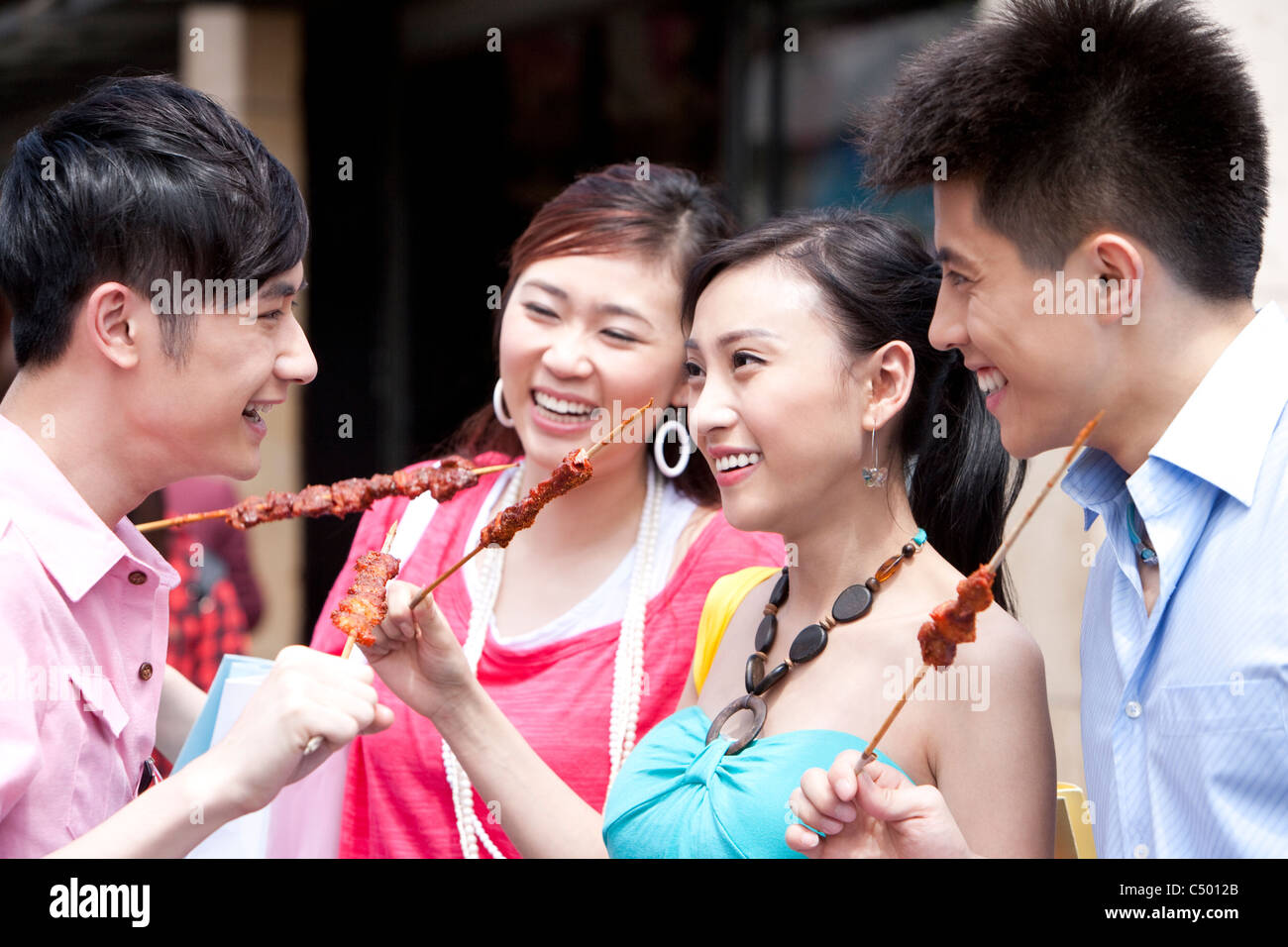 Four Friends Eating Lamb Kebabs Stock Photo - Alamy