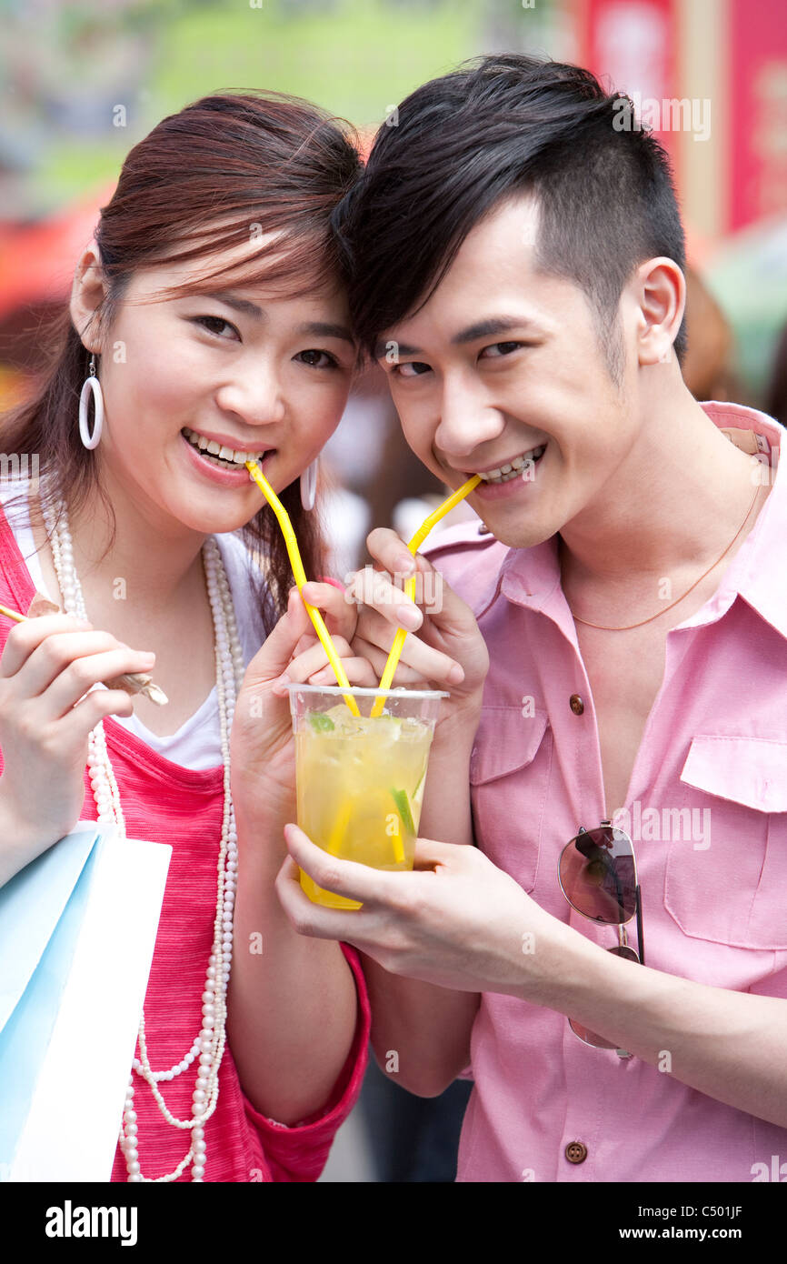 Couple Sharing a Drink Stock Photo - Alamy