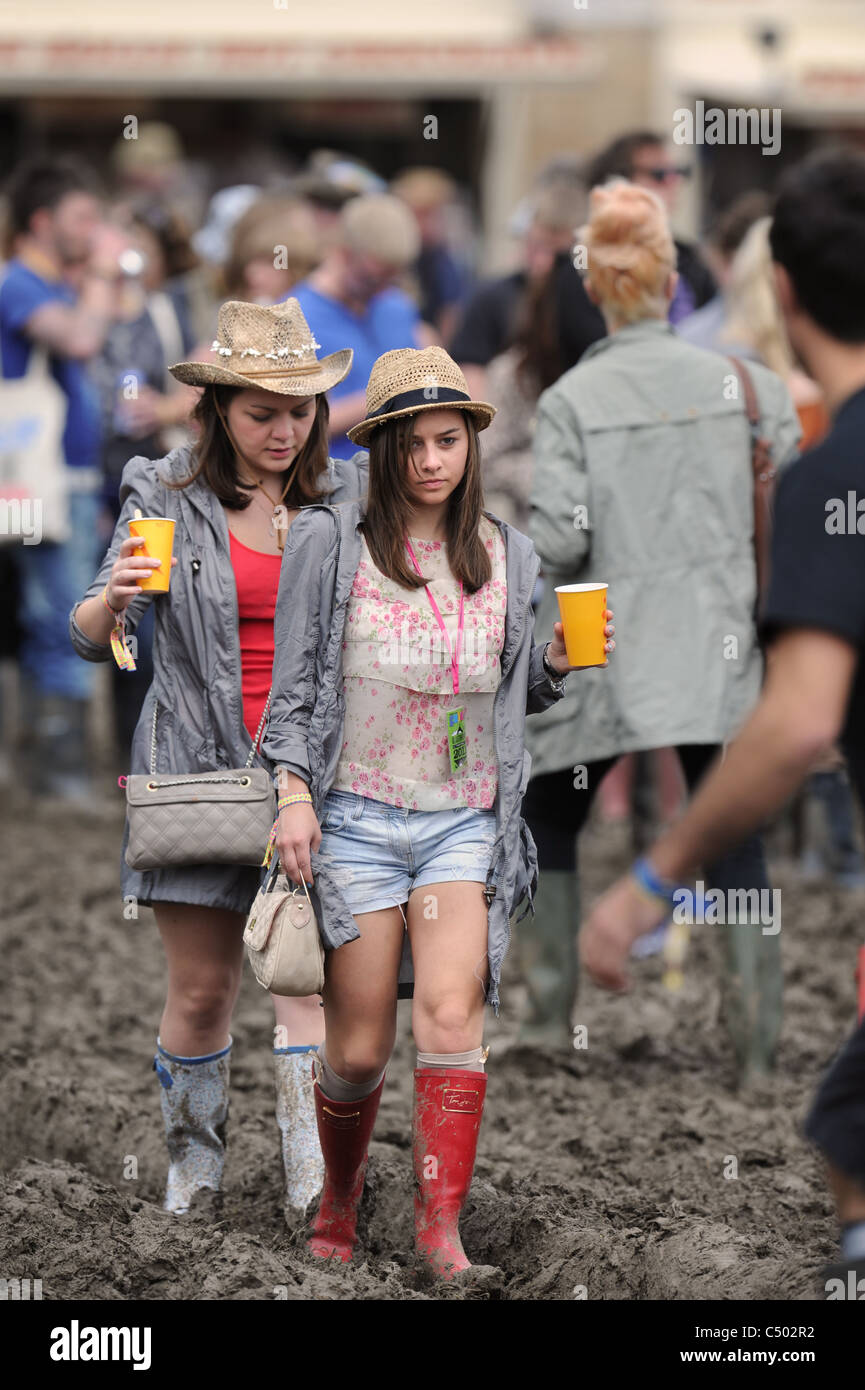 Two girls in the mud at the Glastonbury Festival 2011 Stock Photo - Alamy